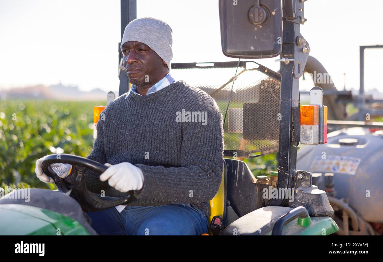 African-american man driving tractor on plantation Stock Photo - Alamy