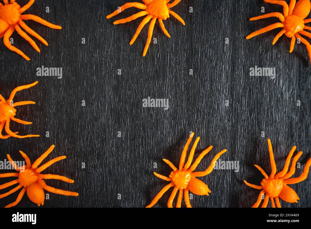 Fake orange spiders on a black background. nice Background for ...