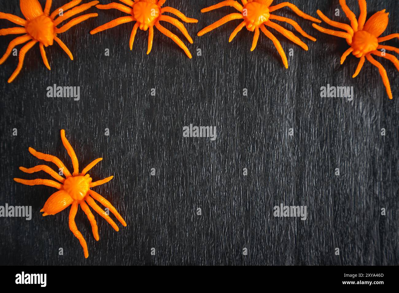 Fake orange spiders on a black background. nice Background for ...