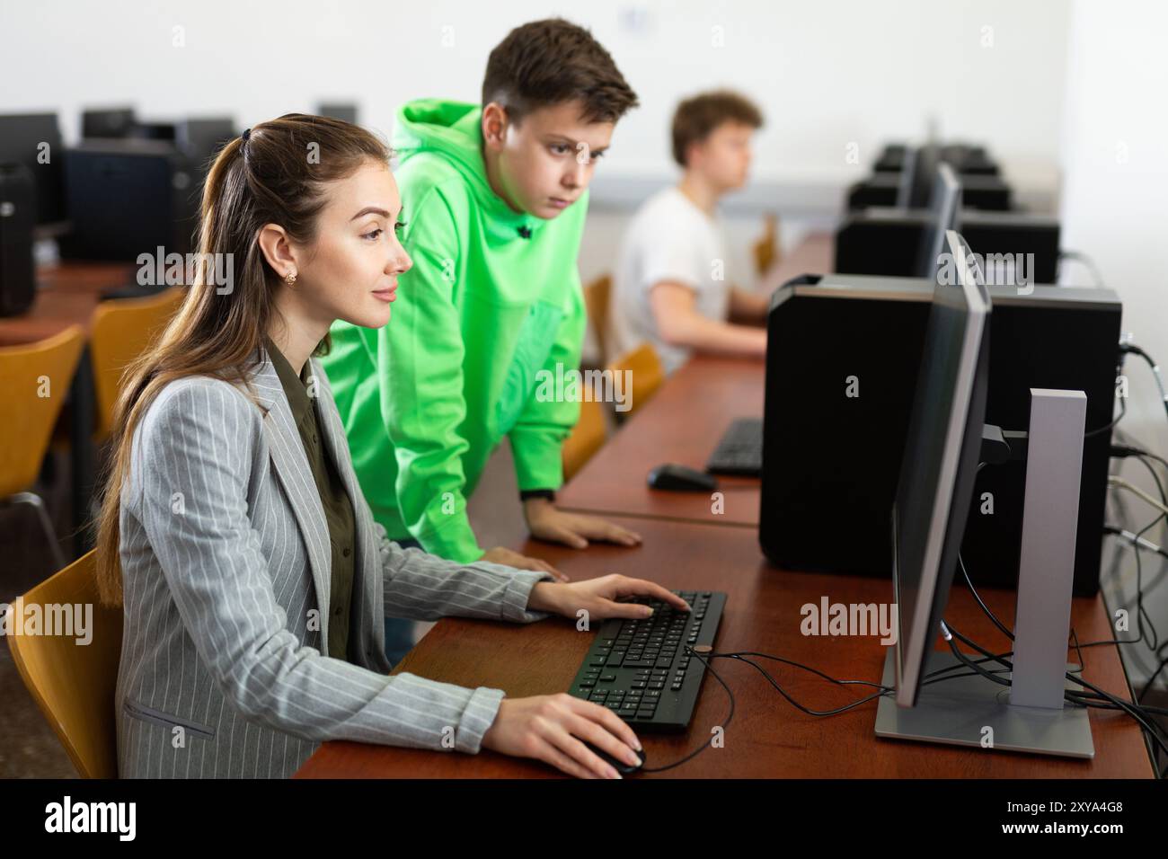 Teacher shows the student how to solve the problem on computer Stock ...