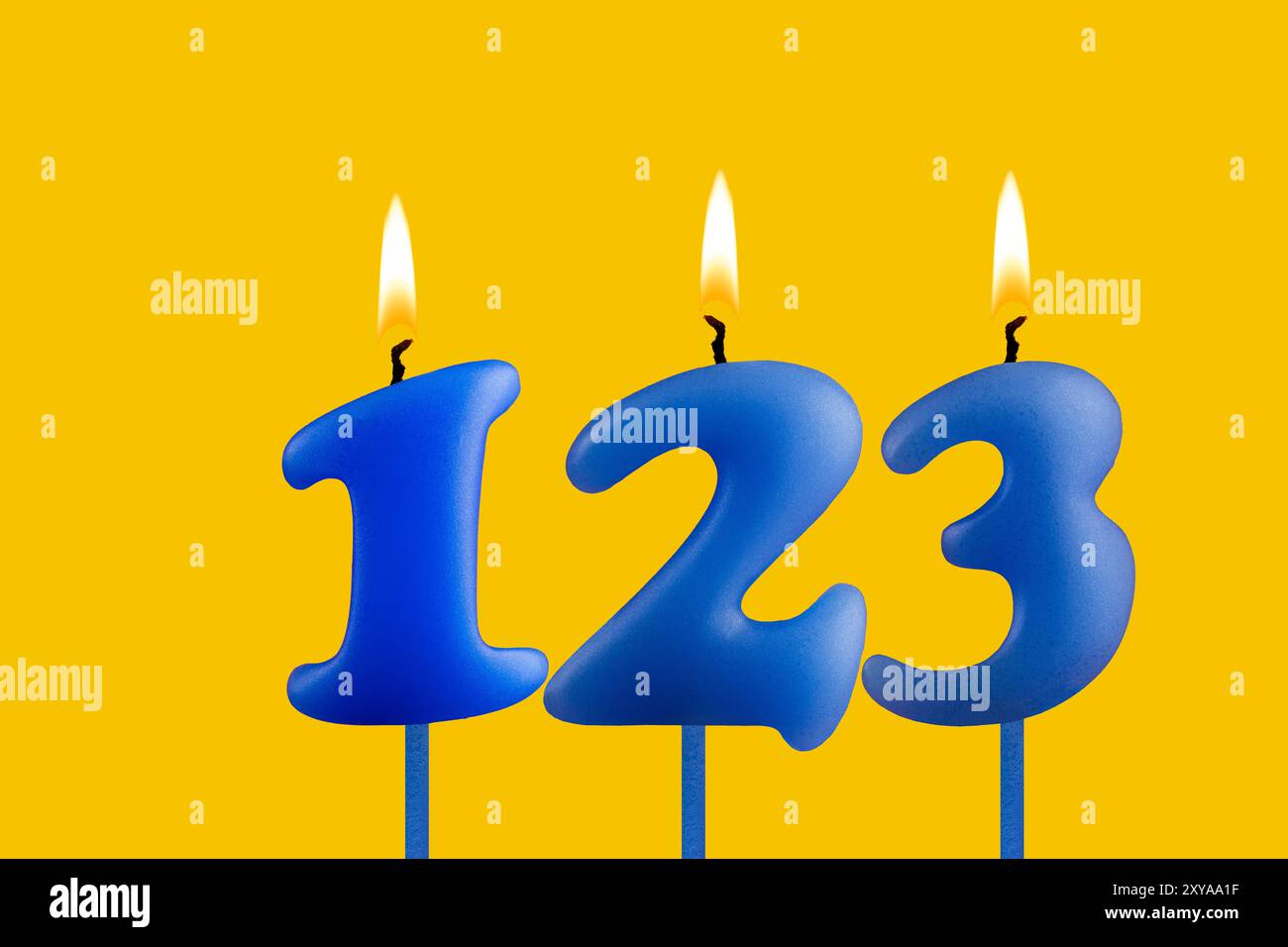Blue birthday candle on yellow background - Number 123 Stock Photo - Alamy