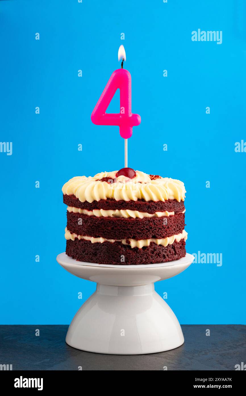 Red velvet birthday cake with number 4 candle Stock Photo - Alamy