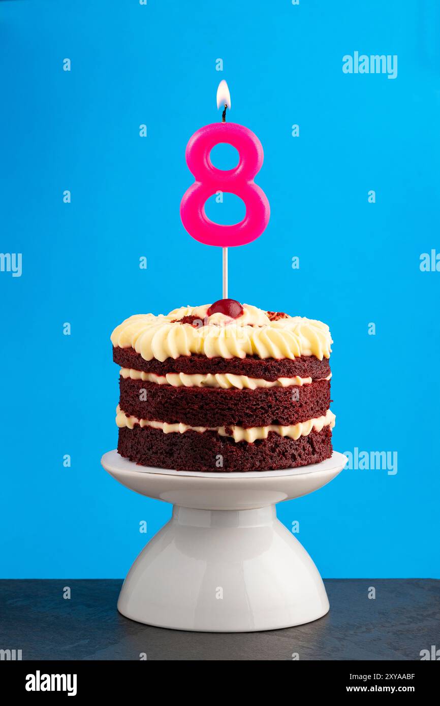 Red velvet birthday cake with number 8 candle Stock Photo - Alamy