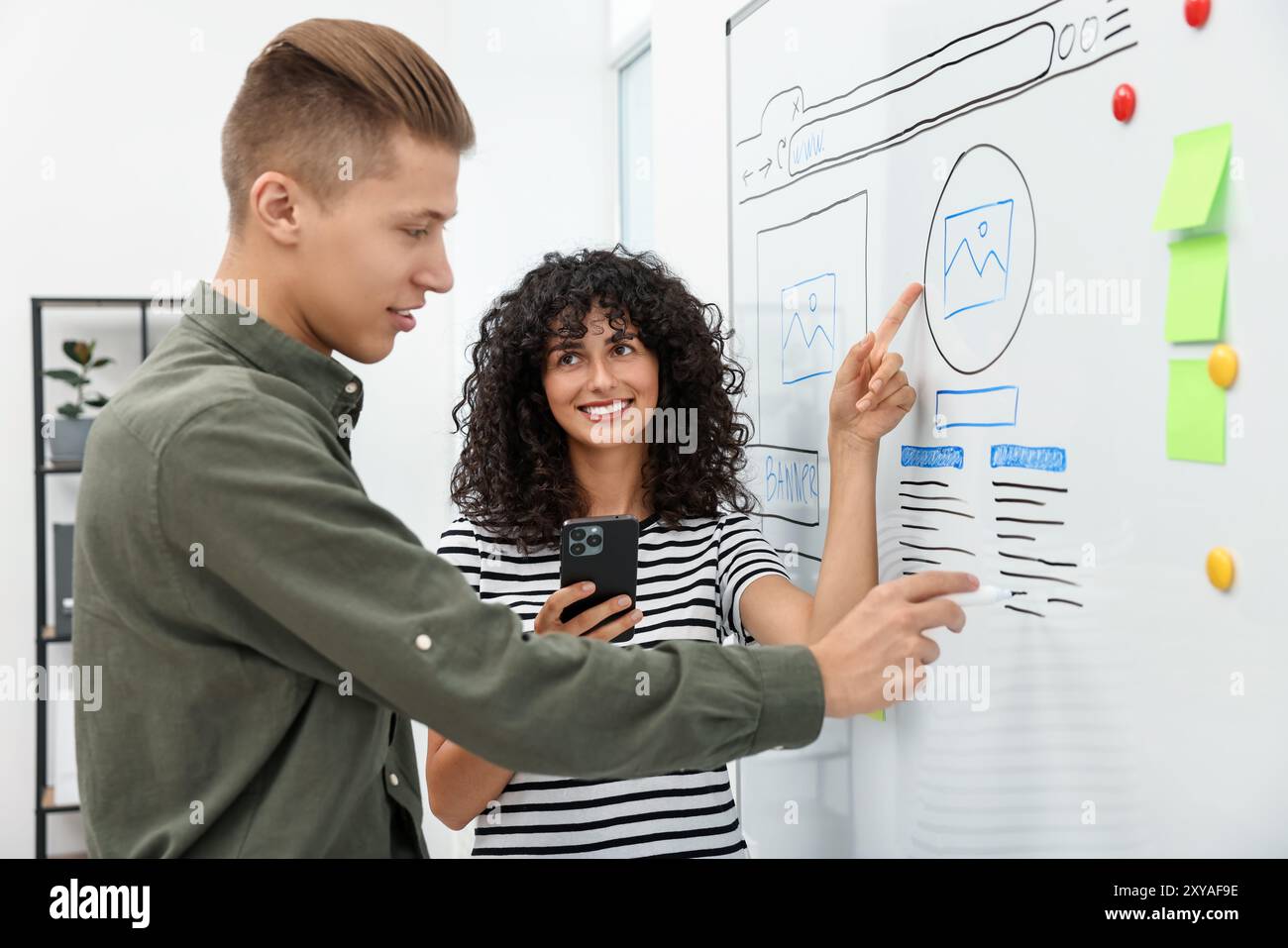 Developing UI design. Man and woman drawing website wireframe on ...