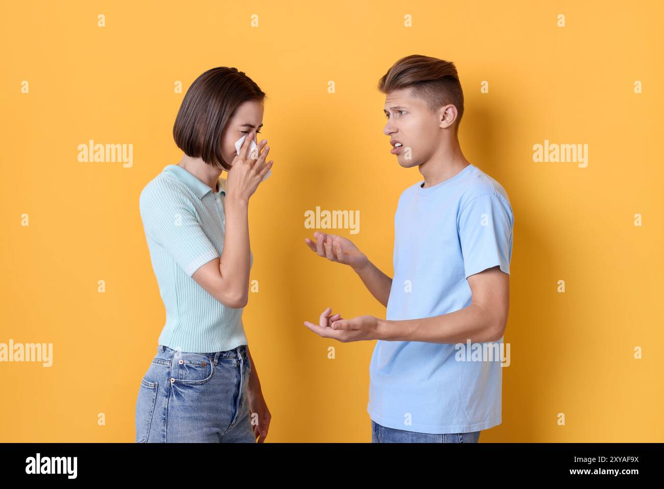 Crying woman arguing with her boyfriend on orange background Stock ...