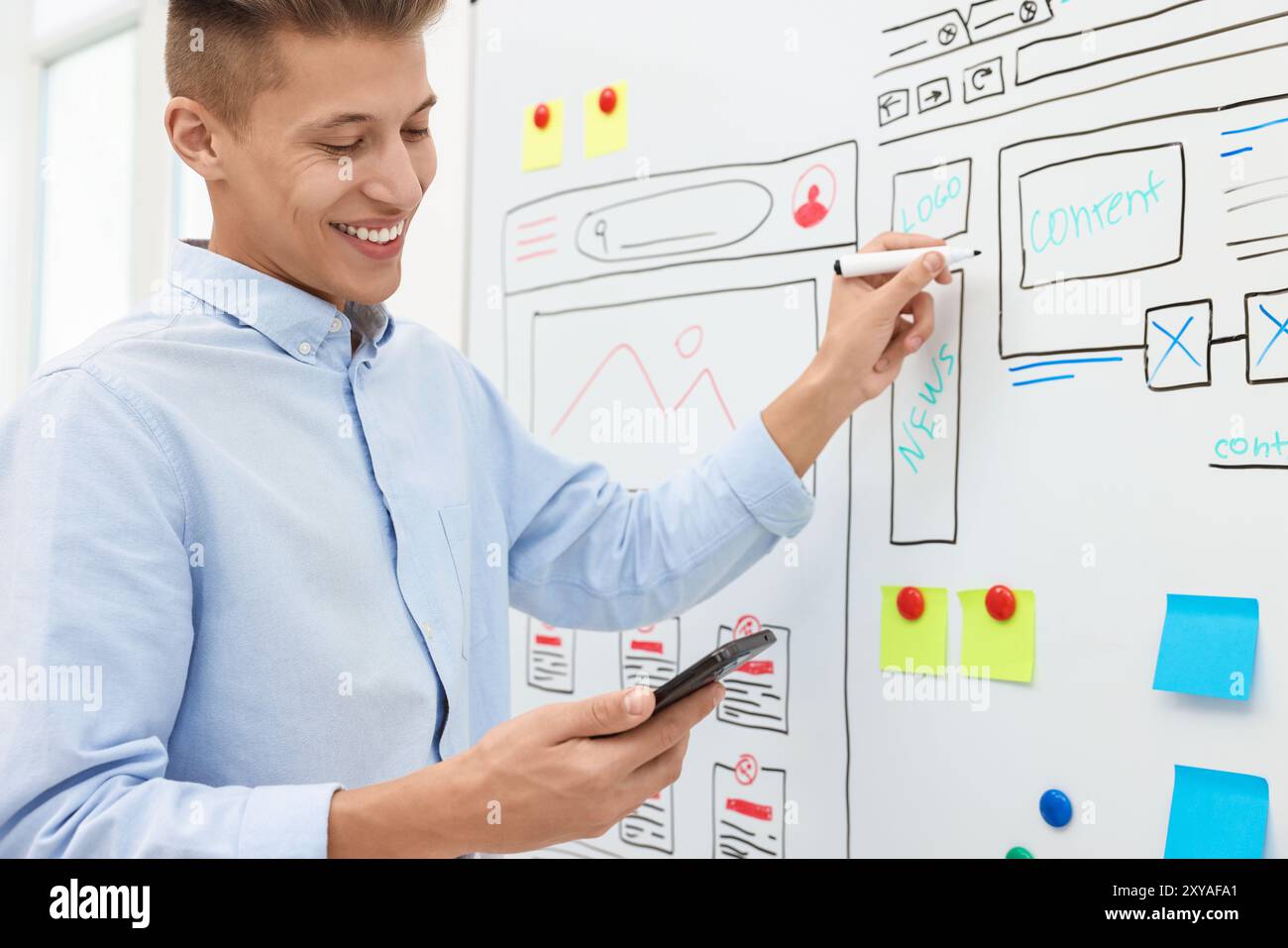 Developing UI design. Man drawing website wireframe on whiteboard ...