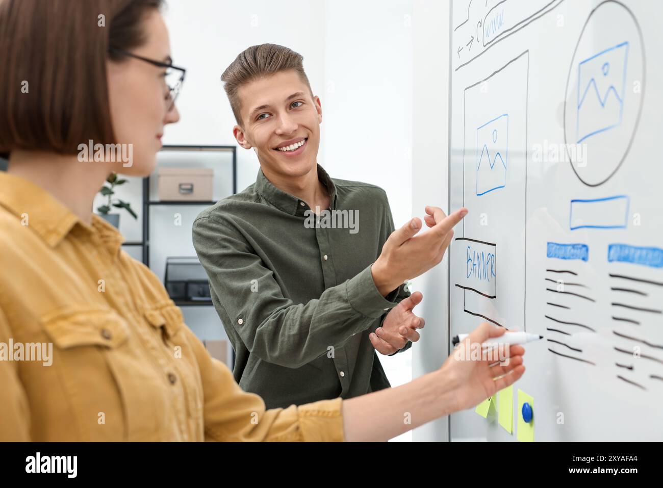 Developing UI design. Man and woman drawing website wireframe on ...