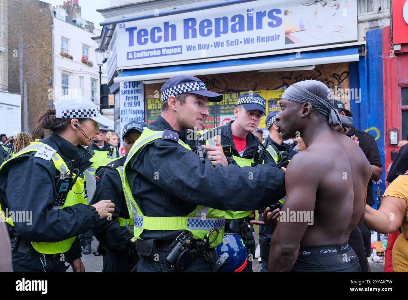 London, UK. A reveller confronts a Territorial Support Group (TSG ...