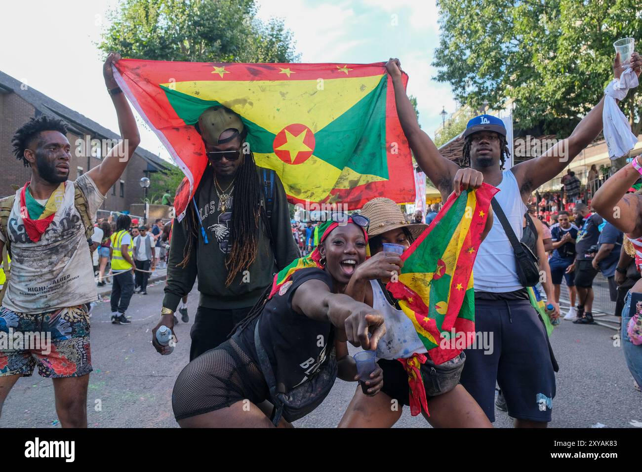 London, UK. Revellers wave the Grenadan flag as they pass the judging ...
