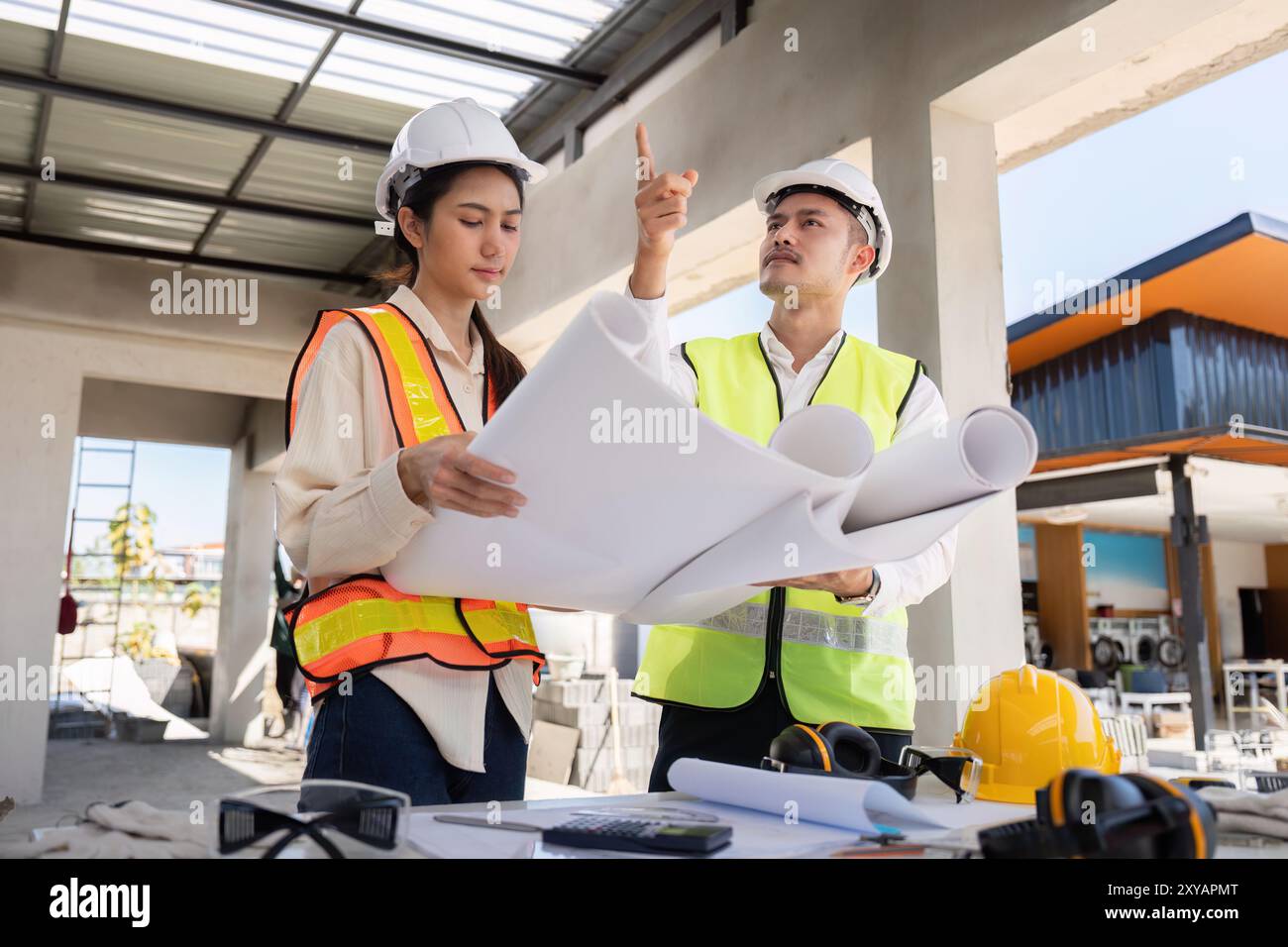 Engineers Discussing Blueprints on Construction Site. Focus on Project ...