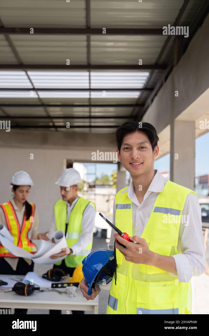 Construction Team Collaborating with Blueprints on Site. Teamwork and ...