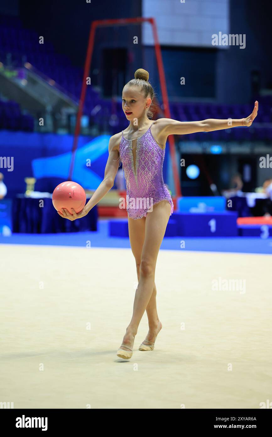 A Rhythmic Gymnast performs with a ball, displaying artistry and ...
