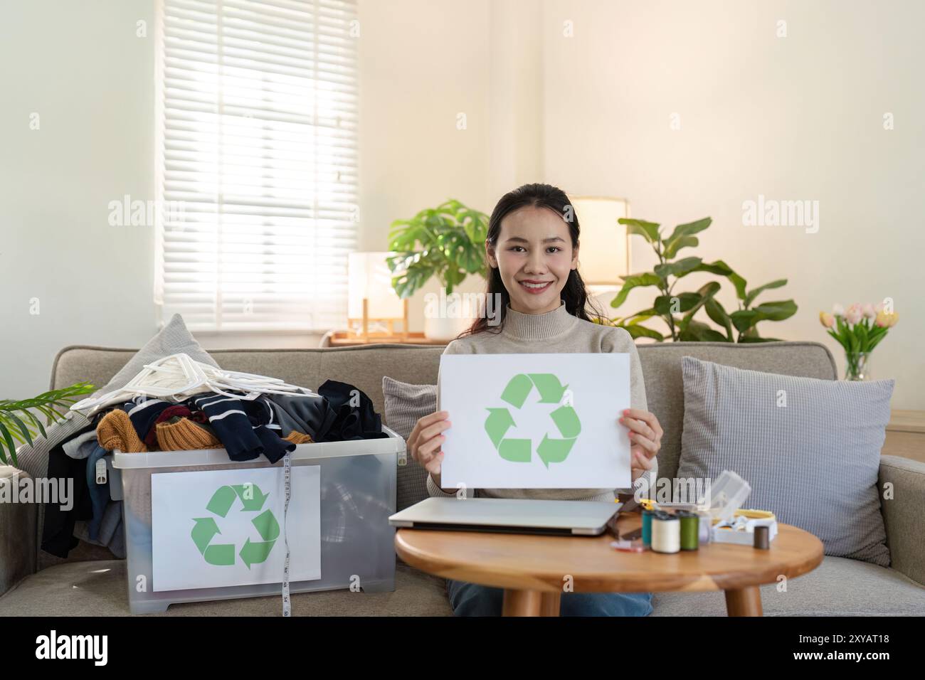 Woman Displaying Recycling Sign with Clothing Bin. Promoting ...