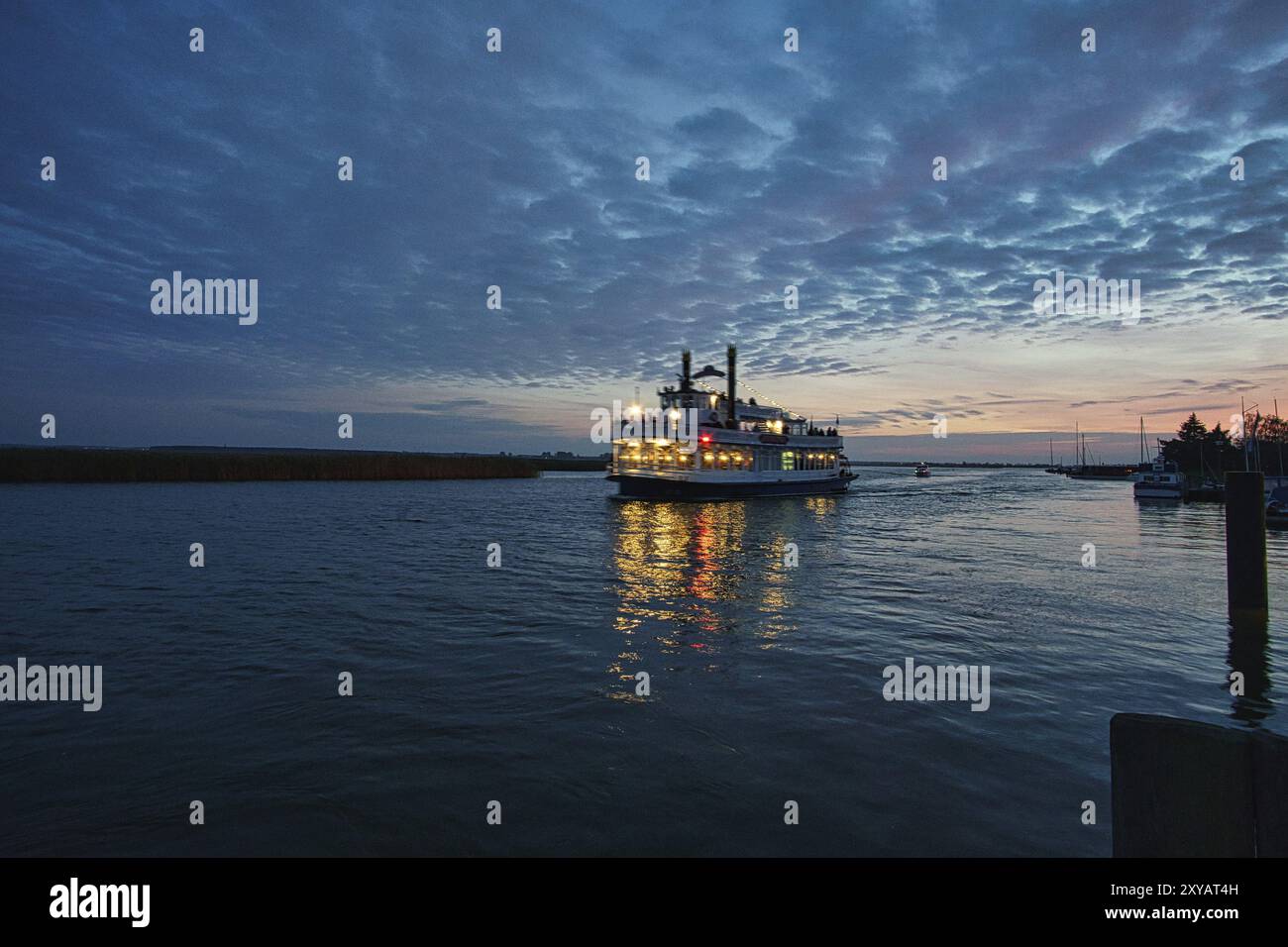 From the harbor in zingst the bodden view with burning sky with steamer ...