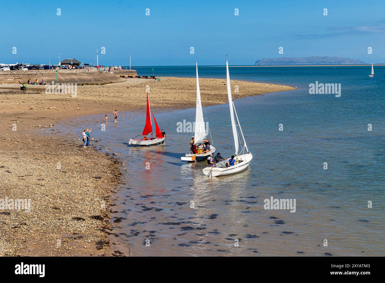 Small yachts leaving Beaumaris Town beach and sailing into the Menai ...