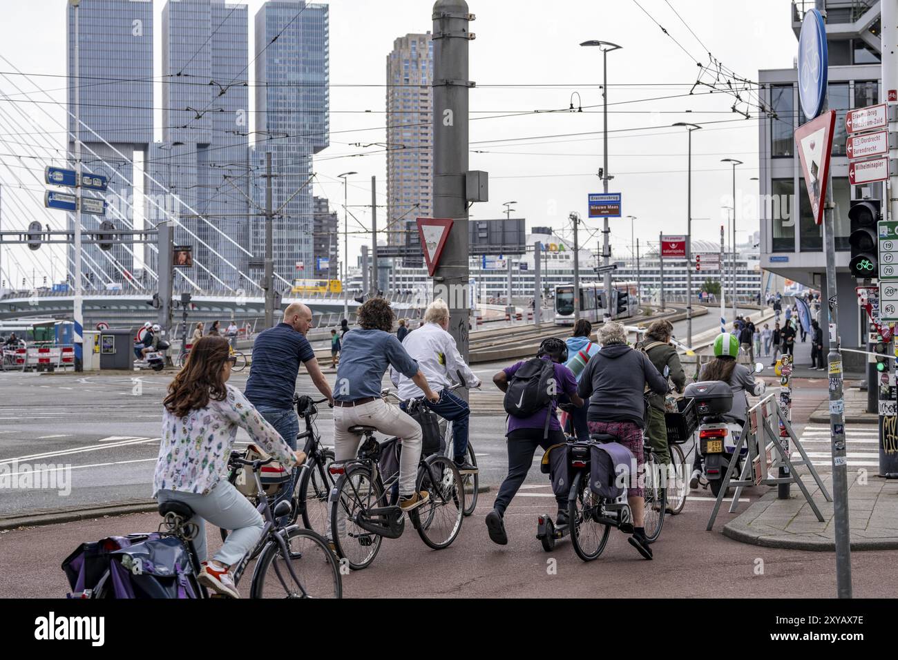 Cyclist on cycle path in front of the Erasmus Bridge over the Nieuwe ...