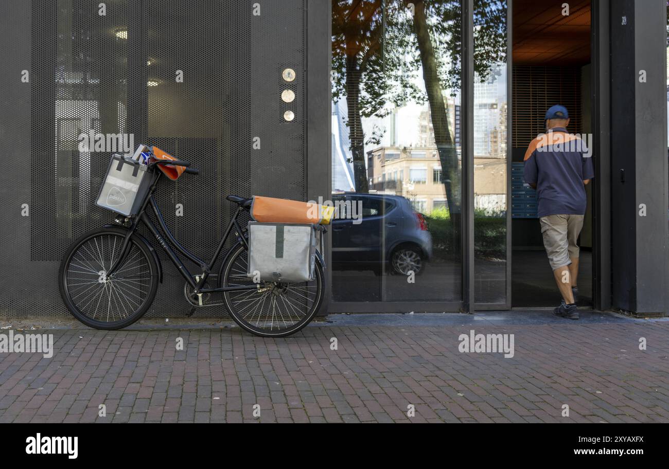 Dutch Post deliverer, with bicycle, in Rotterdam, Netherlands Stock ...
