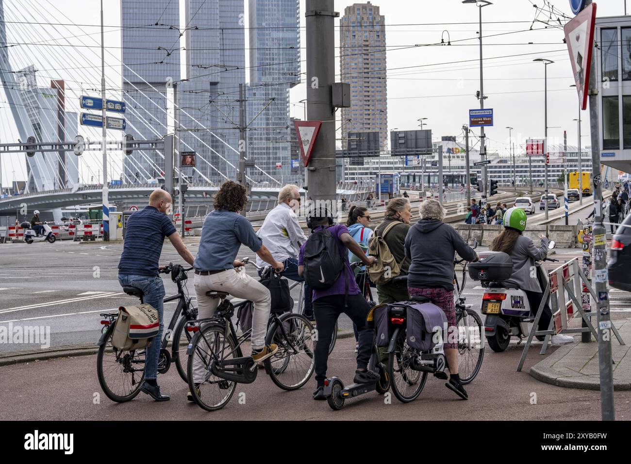 Cyclist on cycle path in front of the Erasmus Bridge over the Nieuwe ...