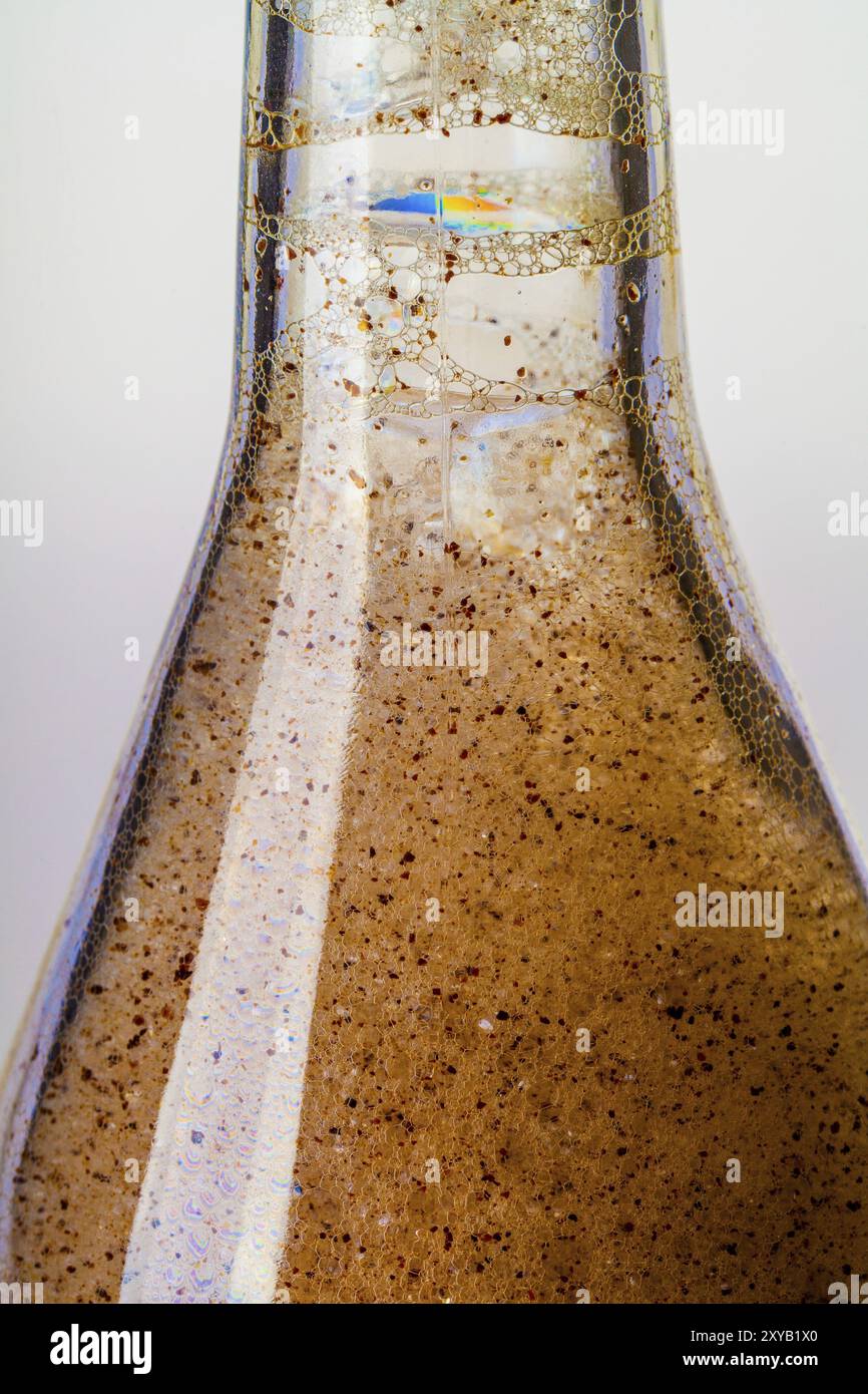 Detail of a clear glass bottle neck with brown foam bubbles Stock Photo ...