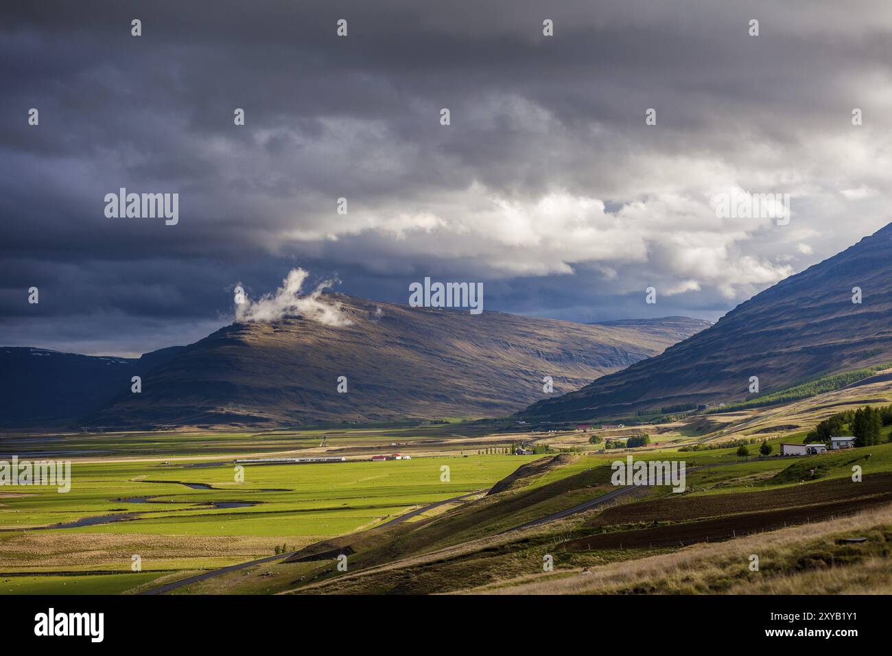 Mountain under a gray overcast sky with an interestingly shaped white ...