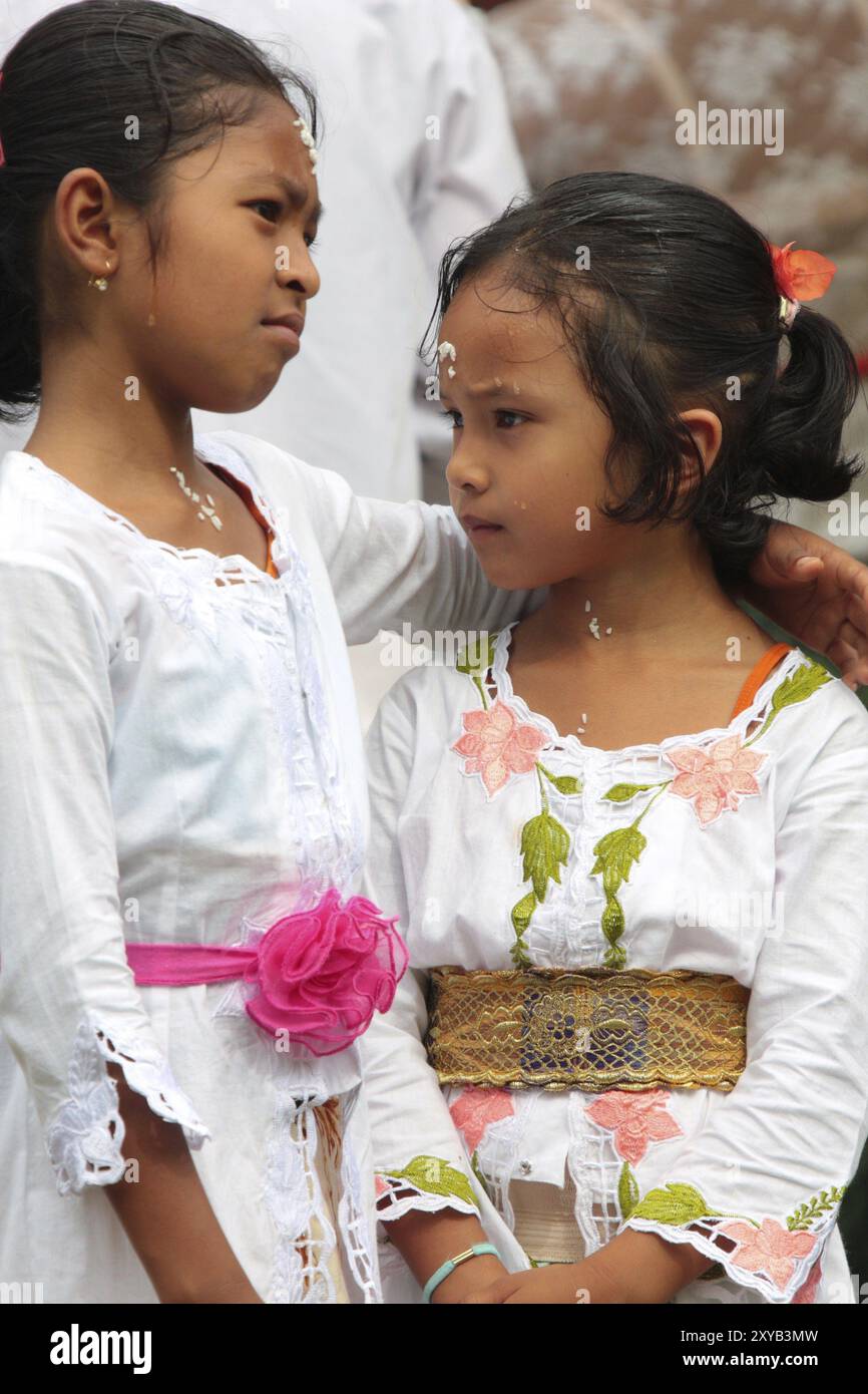 Balinese girls during a ceremony in the temple Stock Photo - Alamy