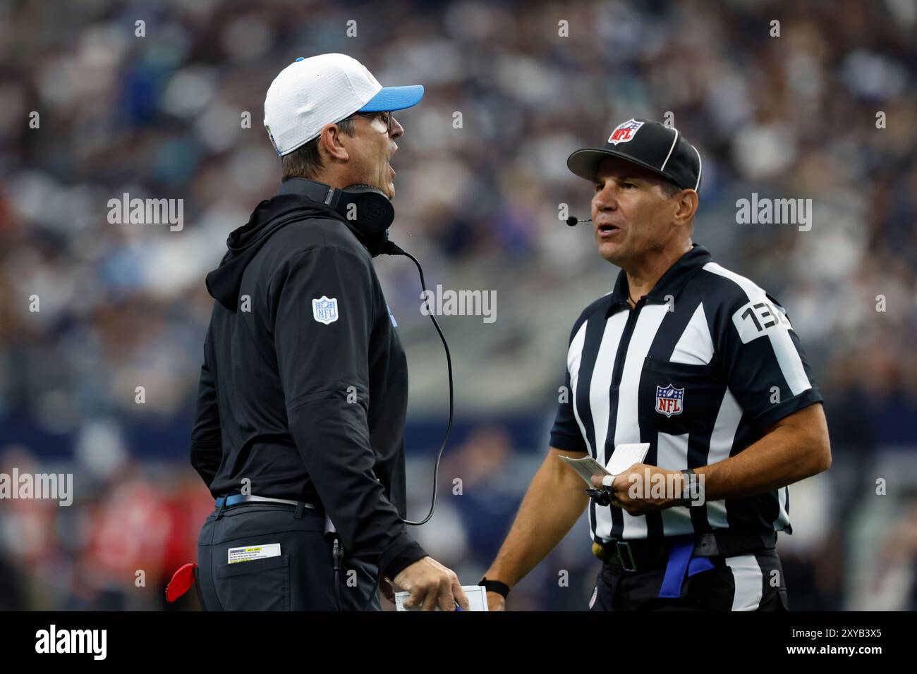Los Angeles Chargers head coach Jim Harbaugh and side judge Frank ...