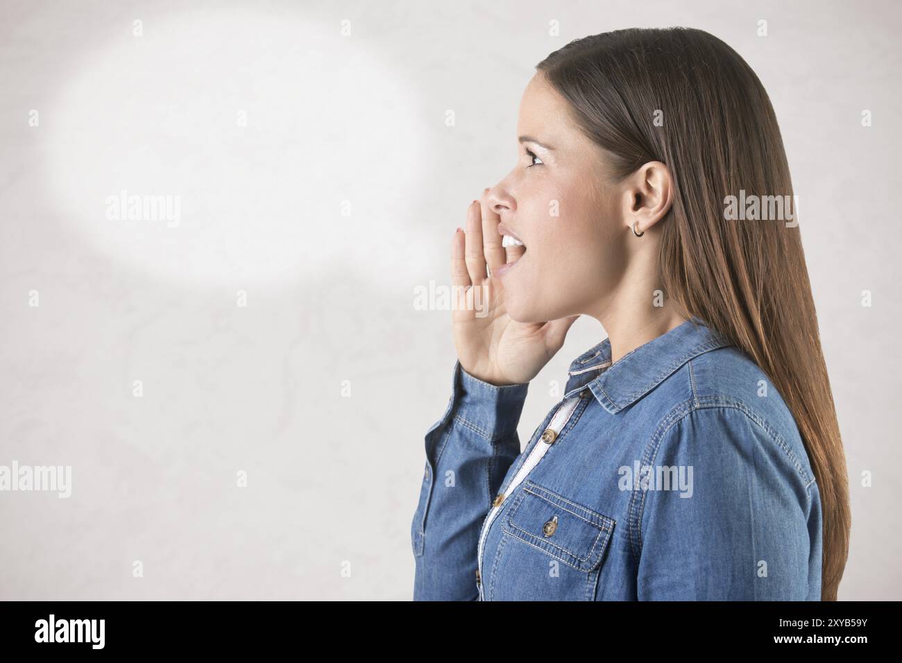 Close up of a womans face, telling a secret, in a grey background Stock ...