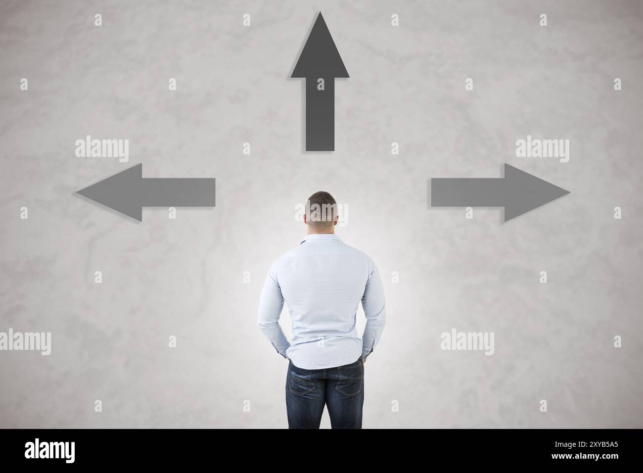 Backside of a young fit man with arrows around him, isolated in grey ...