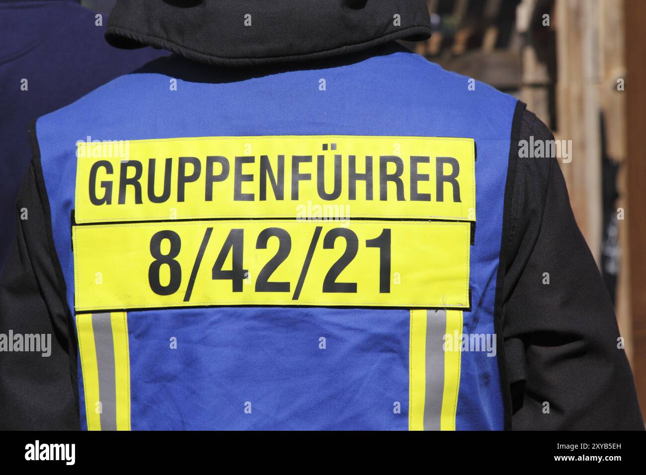 Rear view of firefighter, group leader Stock Photo - Alamy