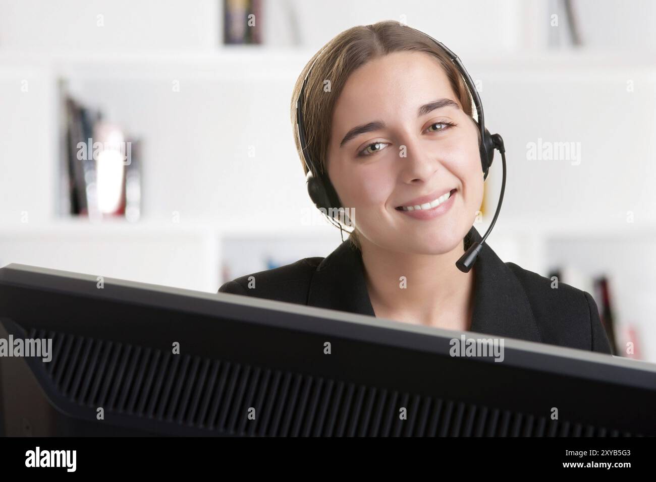 Corporate woman talking over her headset Stock Photo - Alamy