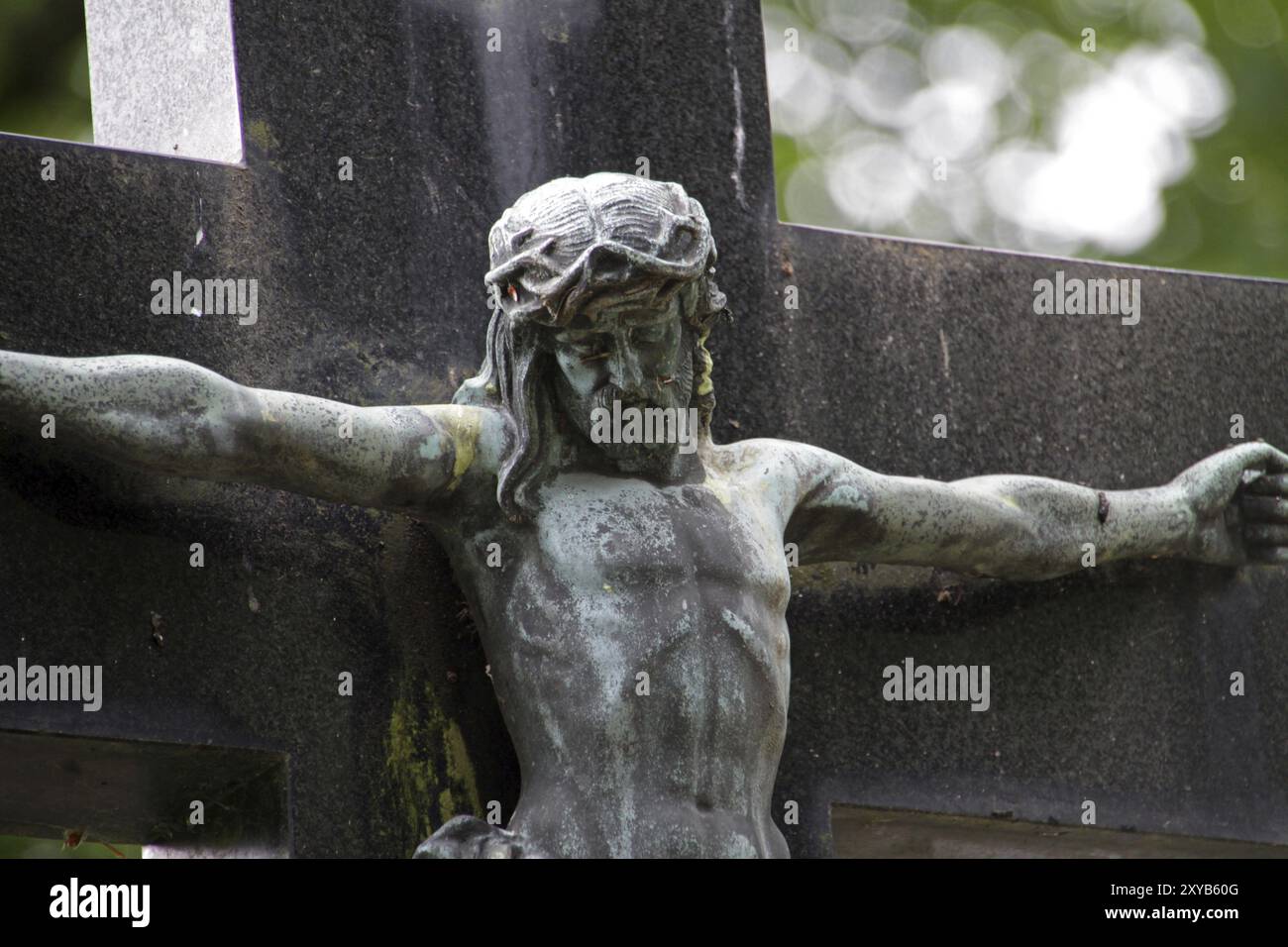 Grave cross with crucified man Stock Photo - Alamy