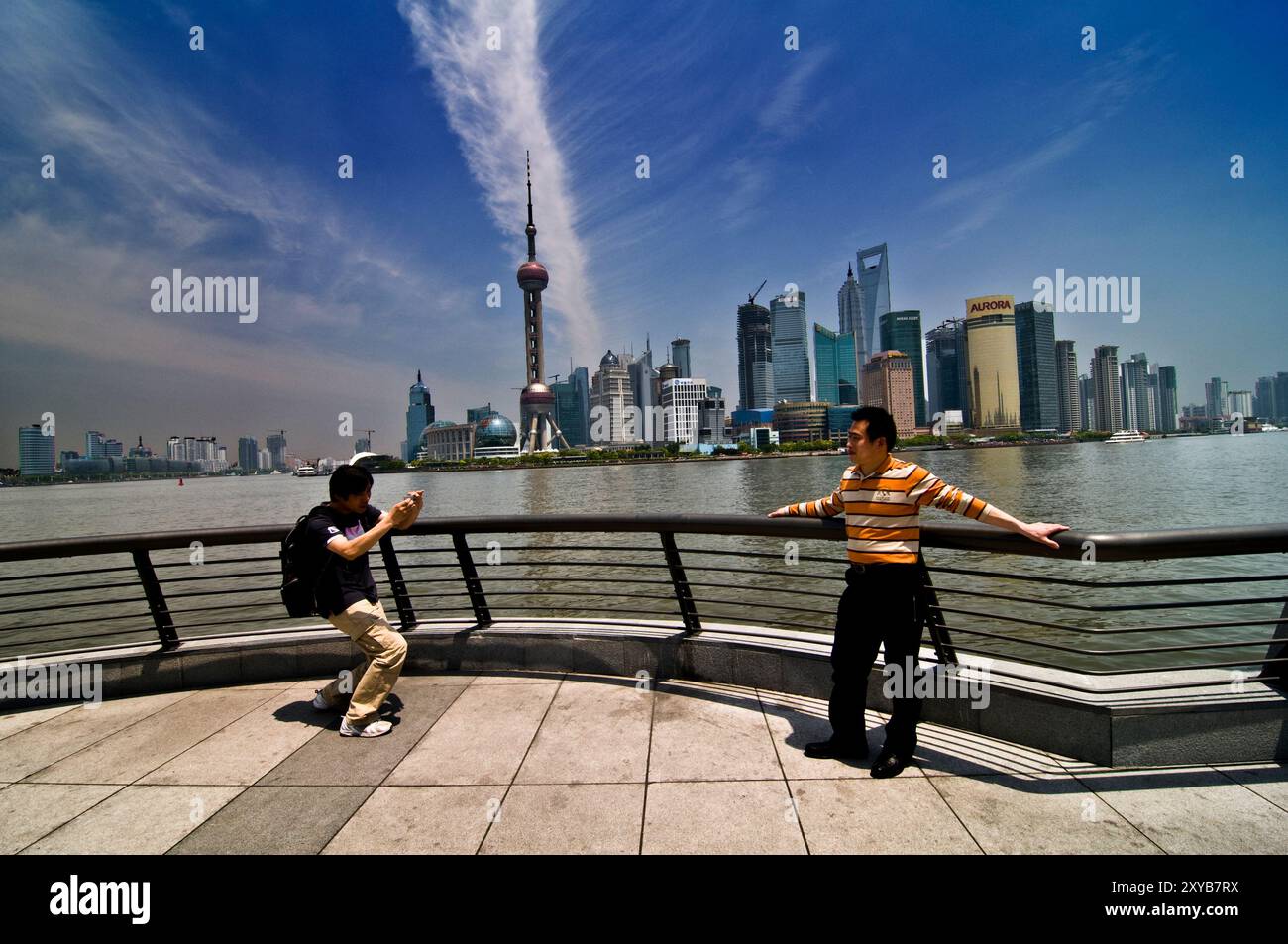 Tourist on the promenade in Puxi overlooking Shanghai's Pudong's ...