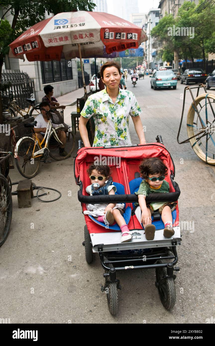 Twins with their Chinese nanny in China Stock Photo - Alamy