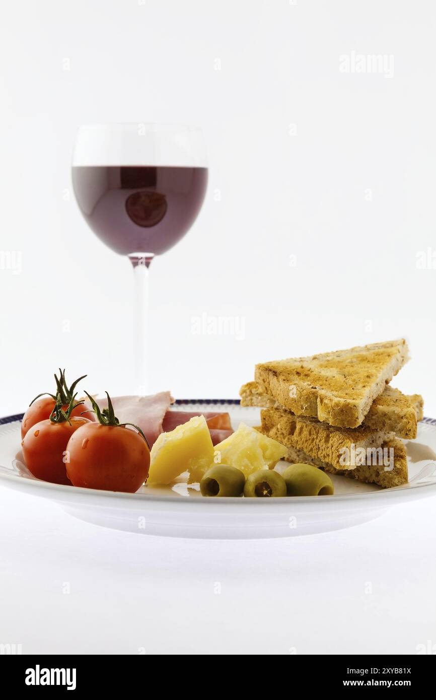 A tasty mediterranean plate match to a red wine glass Stock Photo - Alamy
