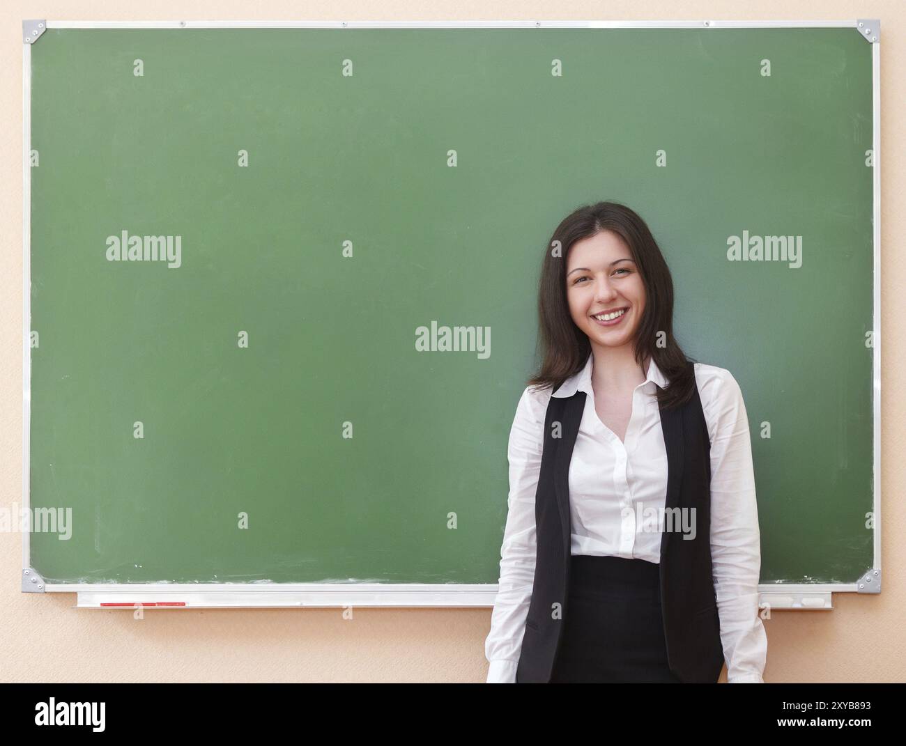 Student girl standing near clean blackboard in the classroom Stock ...