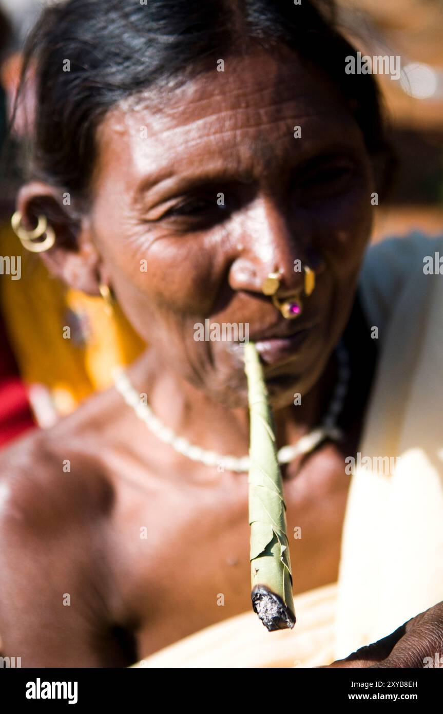 A tribal woman smoking a traditional bidi cigarette in Orissa, India ...