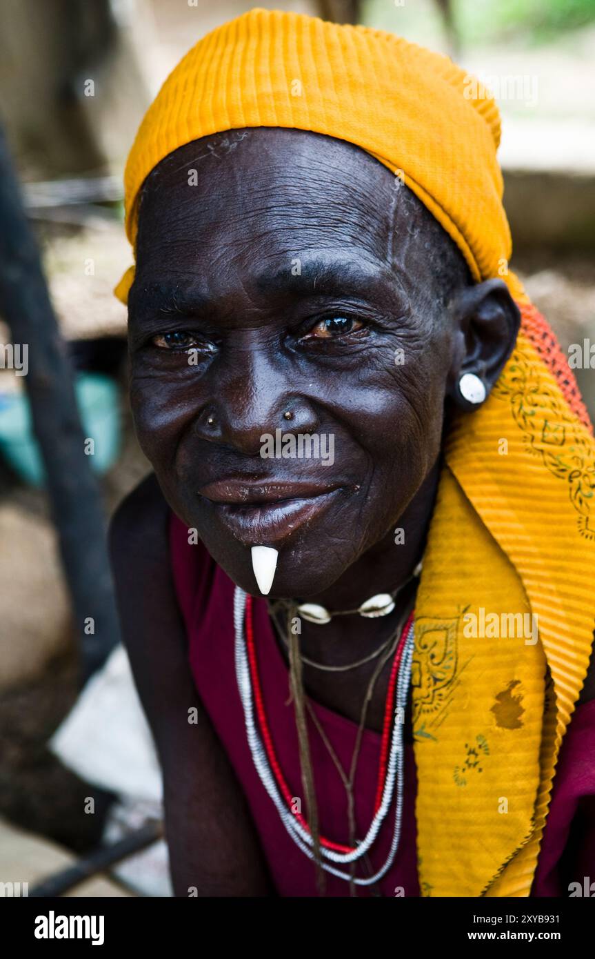 A tribal woman with a wild boar tooth inserted to her lower lip. Photo ...