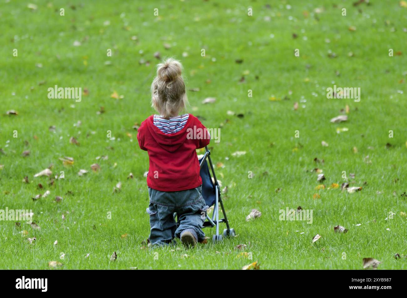 Cute little girl with doll buggy, walking, taken from behind. Cute ...