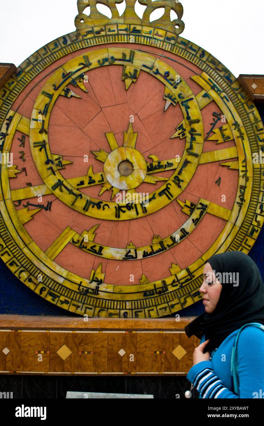 Egyptian college students walking by a colorful decorated wall in ...