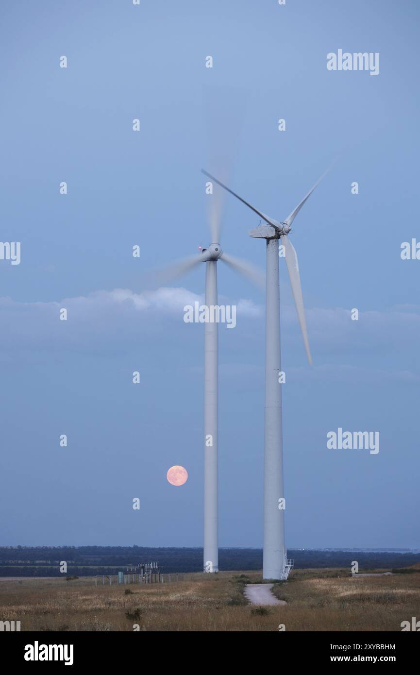 Wind station turbines and full moon at the sky Stock Photo - Alamy