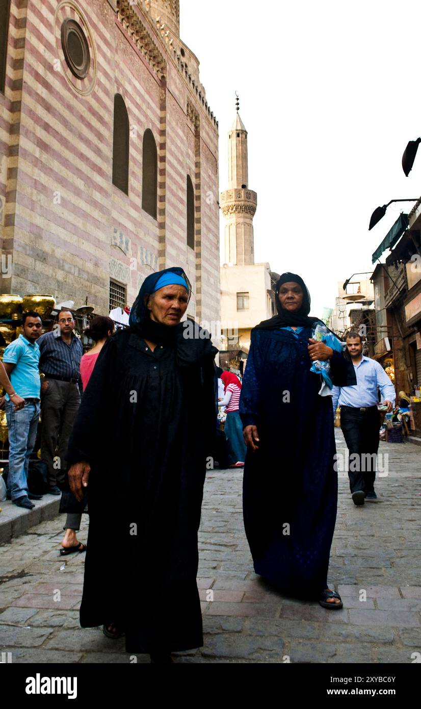 Egyptian women walking by the Al-Ashraf Mosque in Islamic Cairo, Cairo ...