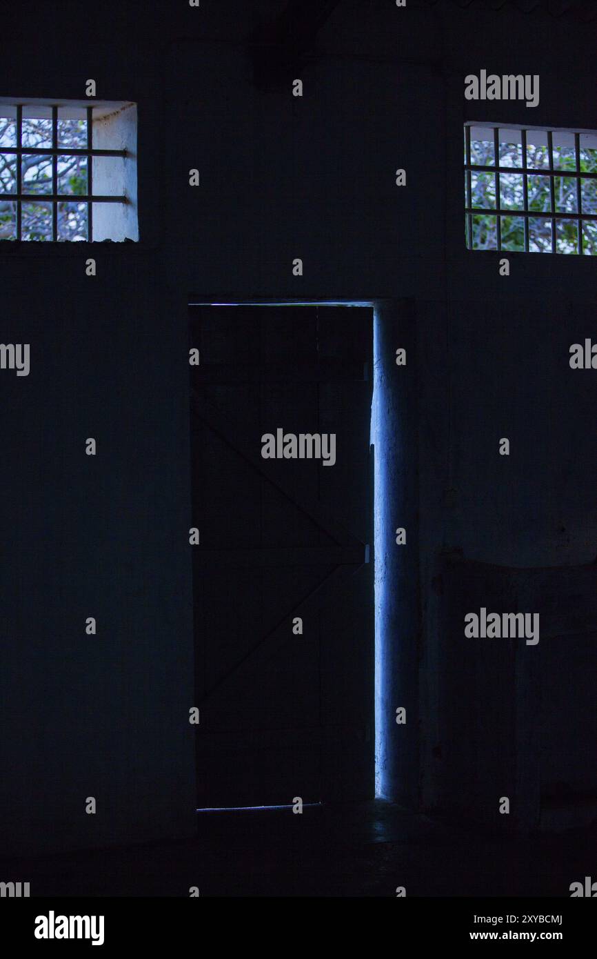 Closed cell door and two windows with narrow strip of light Stock Photo ...