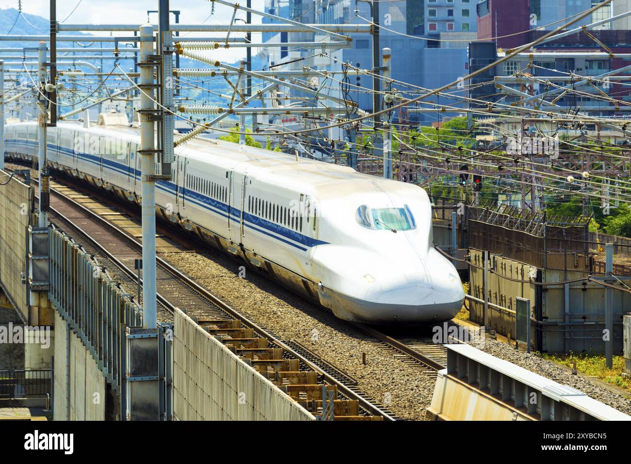 Approaching high speed train shaped like bullet on high elevated rails ...