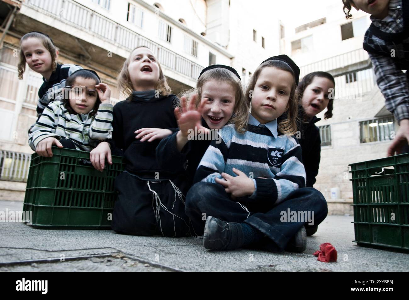 Cheerful & happy. Orthodox Jewish boys having fun in the courtyard of ...
