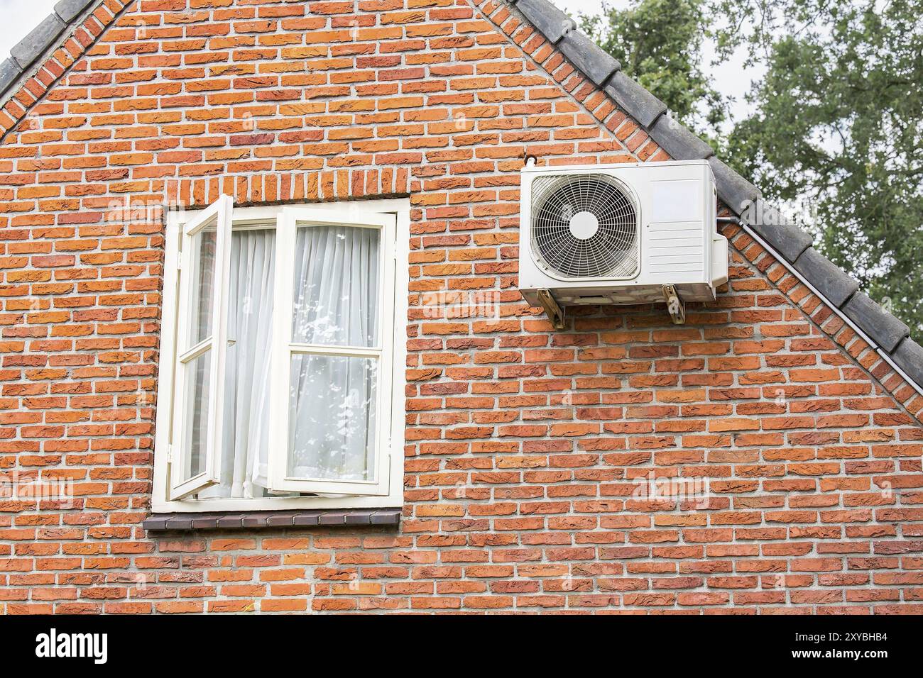Brick wall of home with window and air conditioner Stock Photo - Alamy