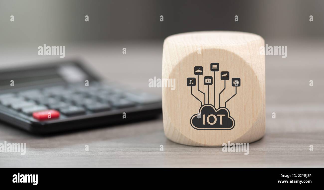 Wooden block with symbol of iot concept and calculator on background ...