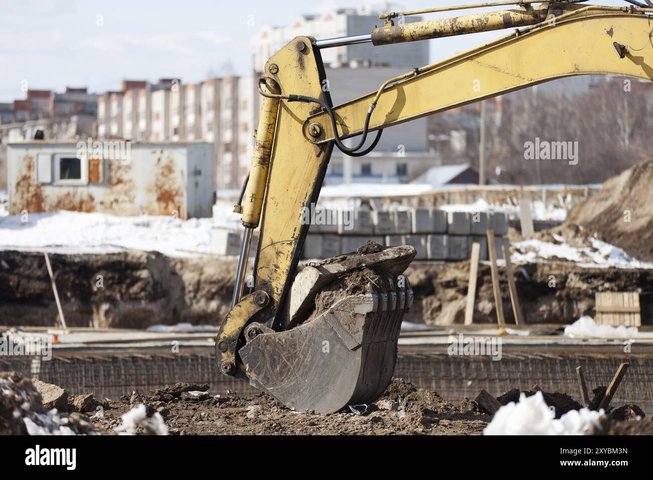Earth digging machine scoop equipment at building construction site ...