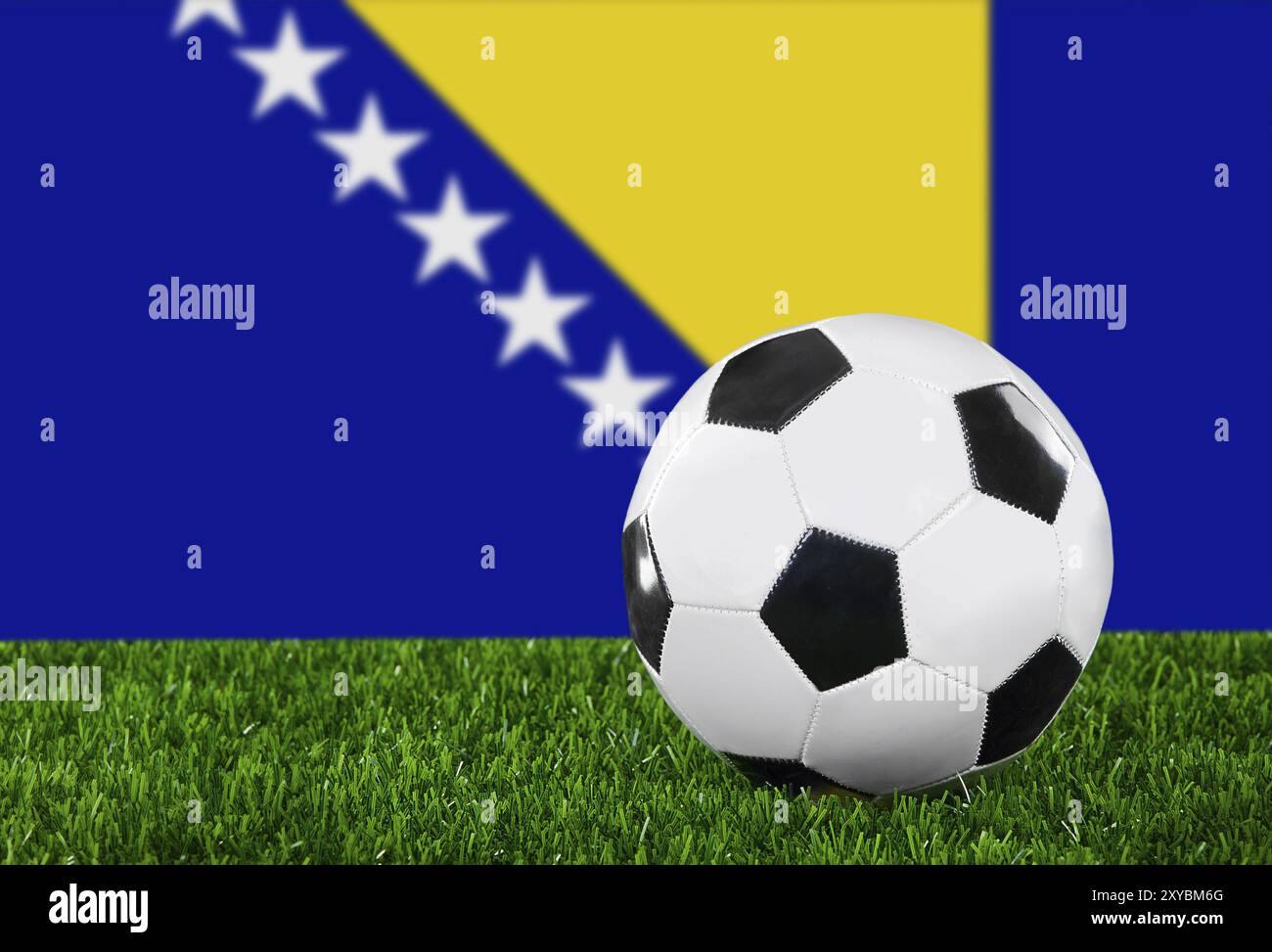 The Bosnia and Herzegovina flag and soccer ball on the green grass ...