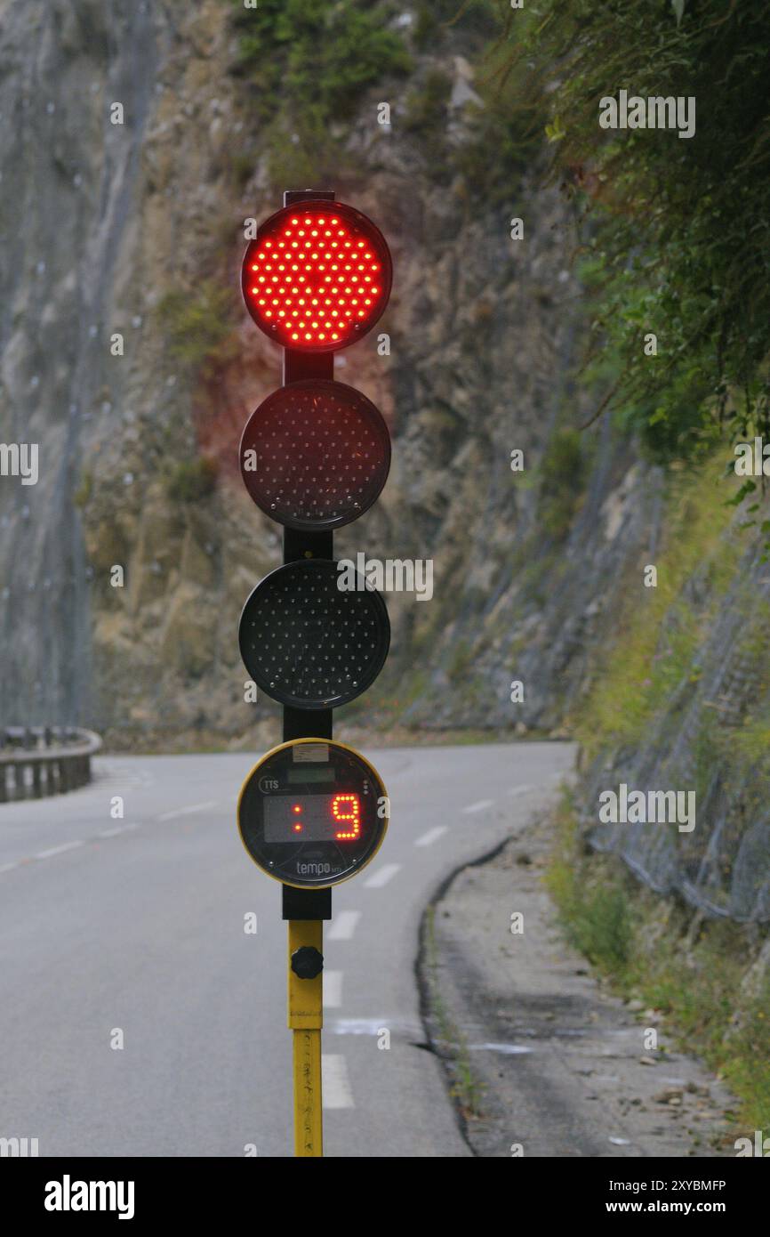 Traffic lights with red light, in France, with a timepiece.Traffic ...
