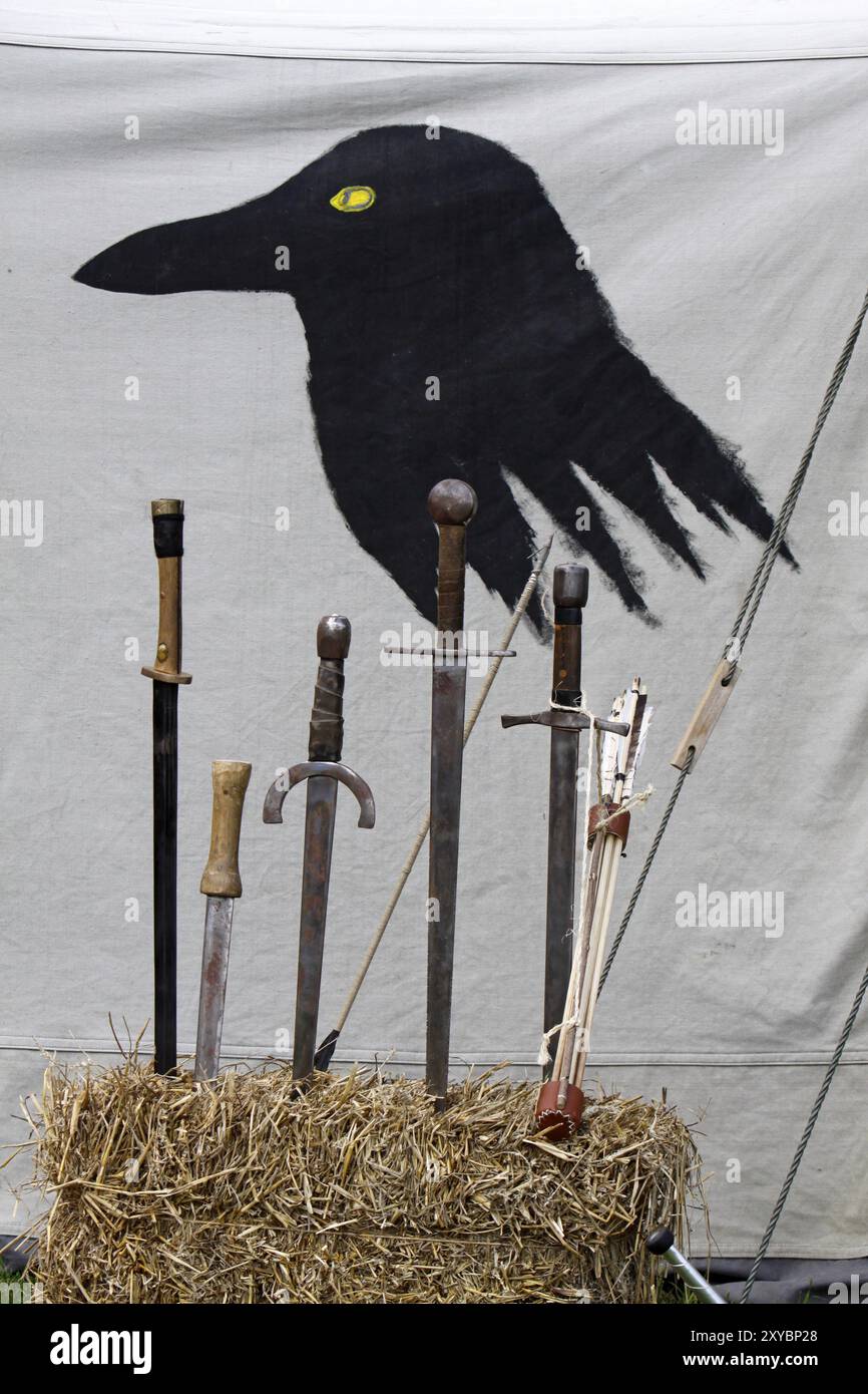 Swords in front of a tent wall painted with a raven Stock Photo - Alamy
